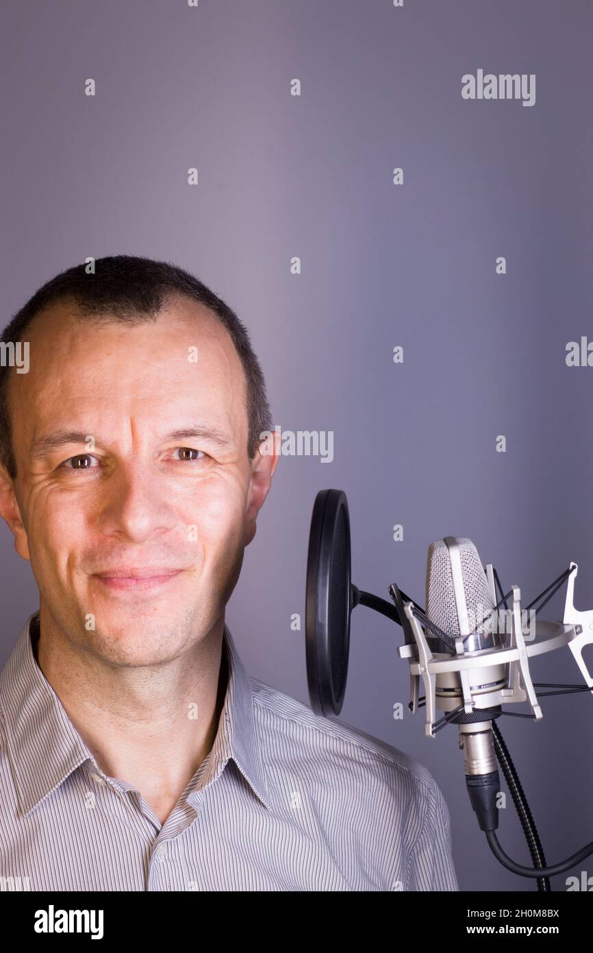 Voiceover artist voice actor in vocal recording studio with larg ...