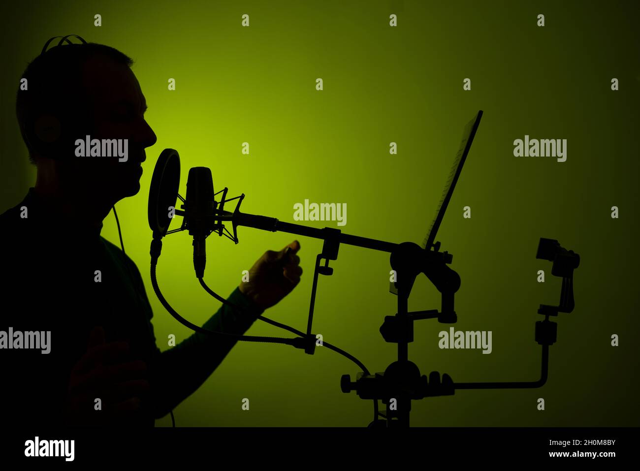 Voiceover artist voice actor in vocal recording studio with larg ...