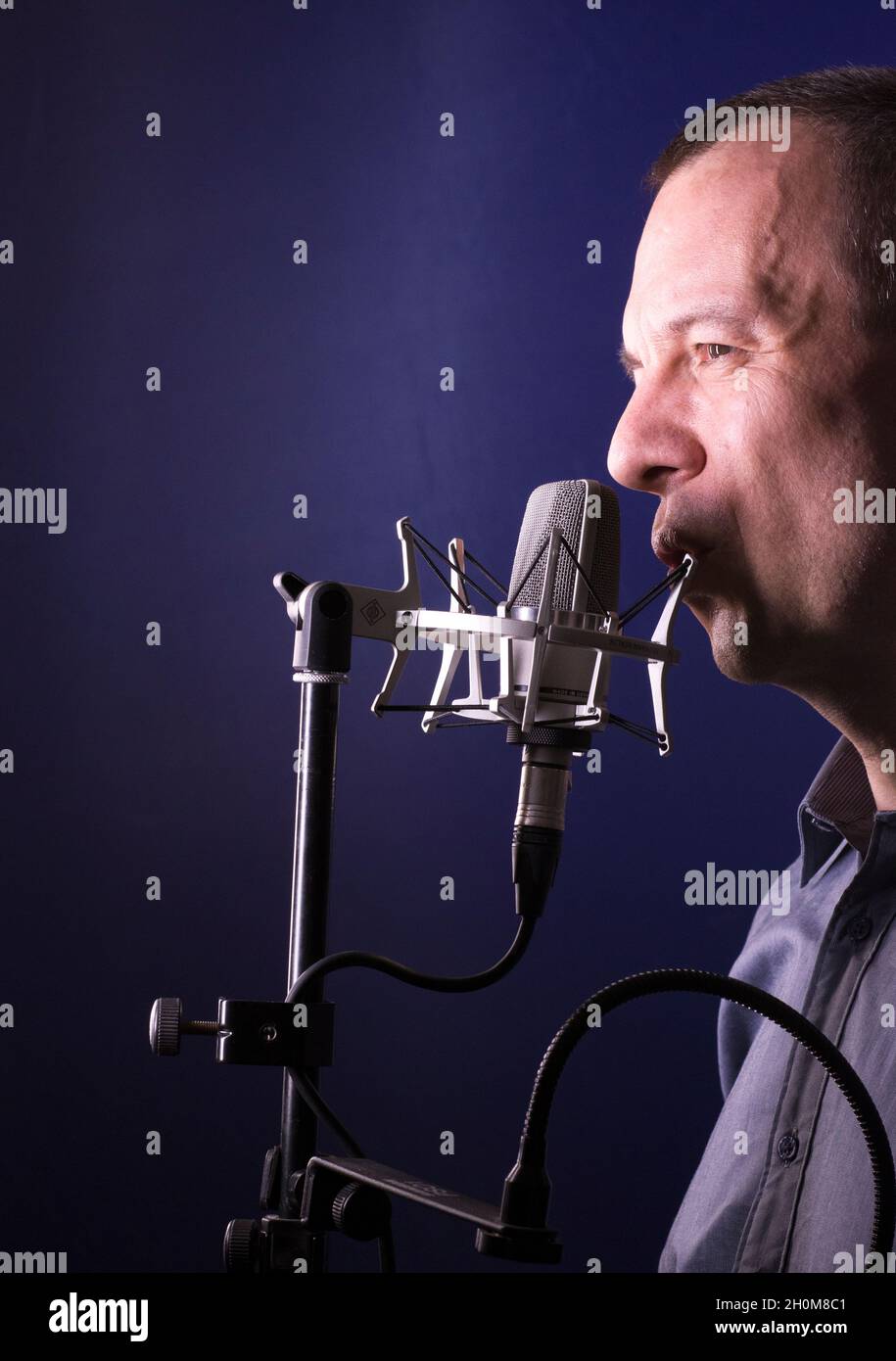 Voiceover artist voice actor in vocal recording studio with larg ...