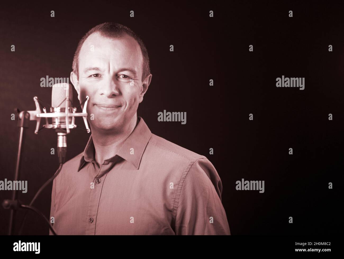 Voiceover artist voice actor in vocal recording studio with larg ...