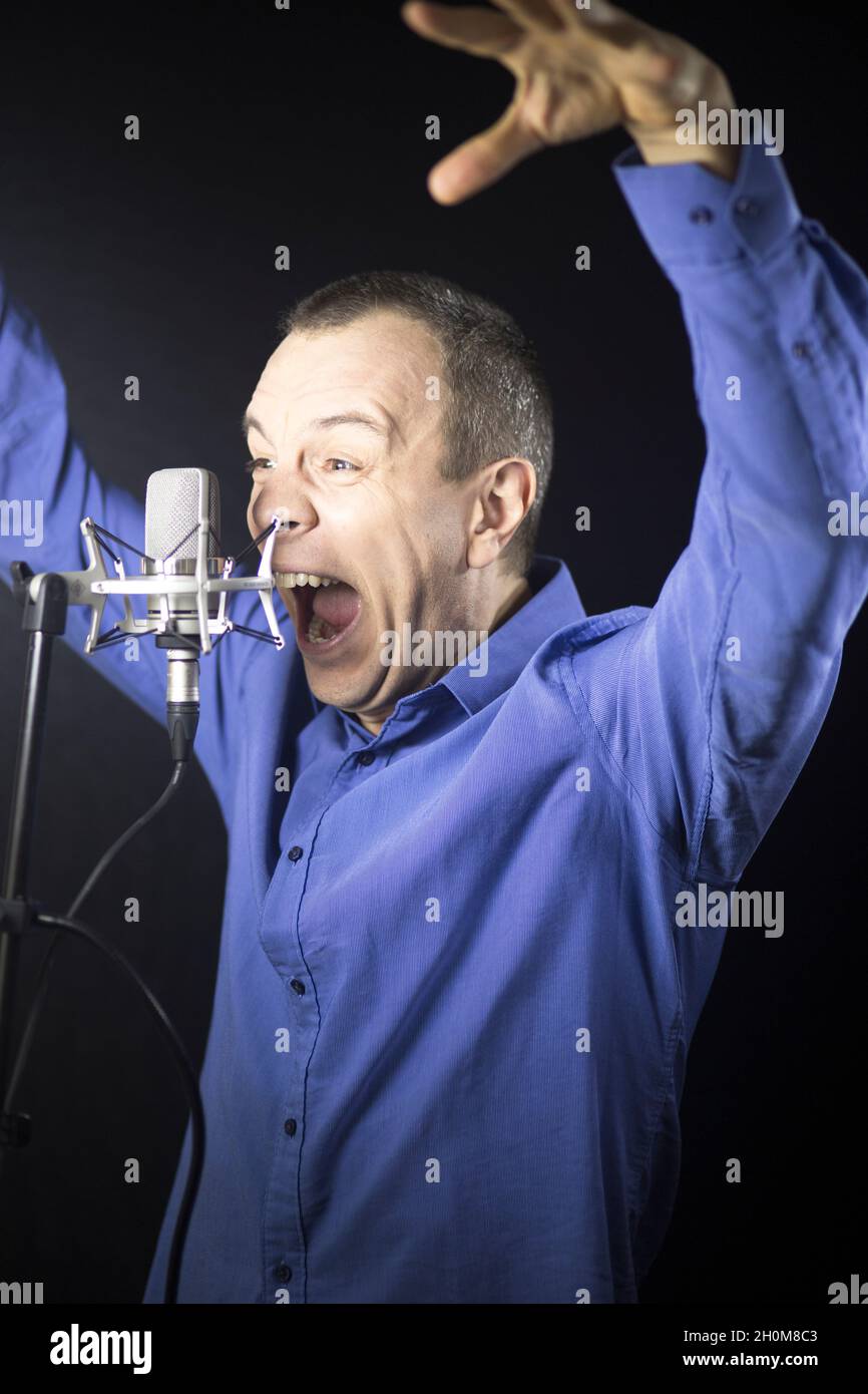 Voiceover artist voice actor in vocal recording studio with larg ...
