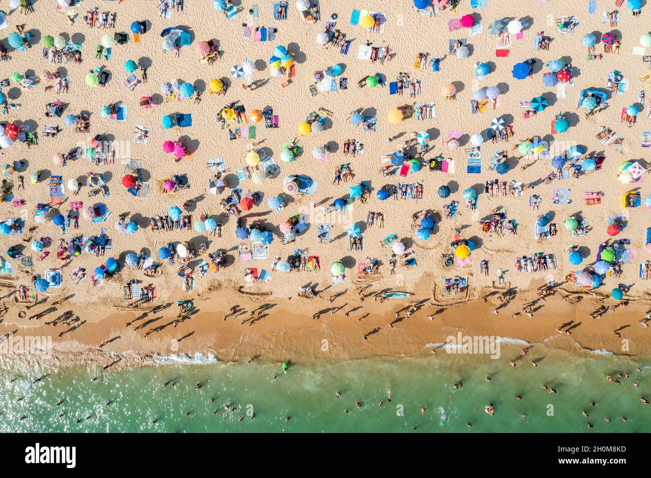 Drone shot of many people enjoying the beach and the ocean - vacation ...