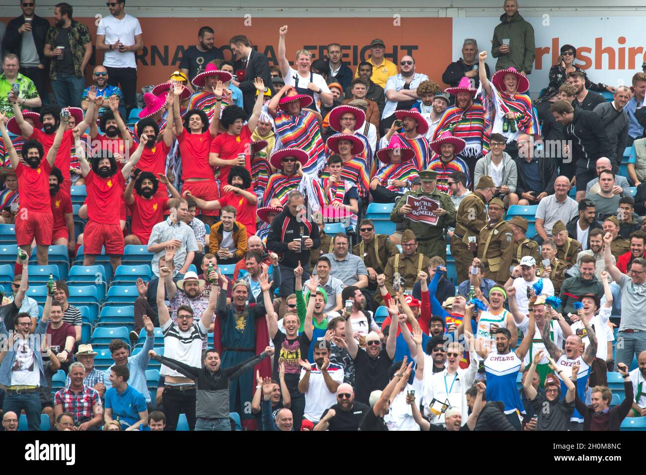 Fans in fancy dress cheer Stock Photo - Alamy