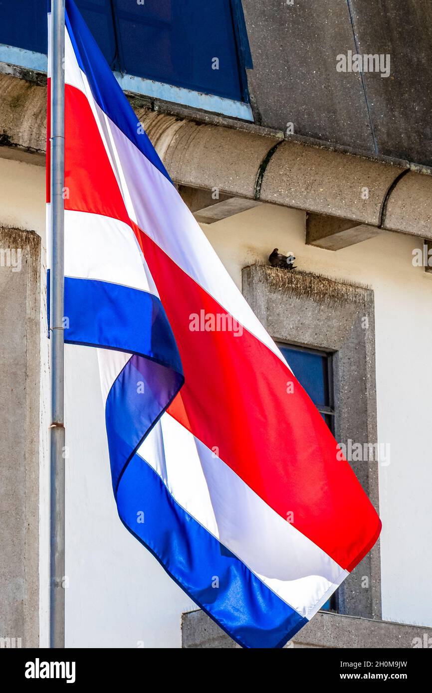 Flag of Costa Rica with old buildings behind Costa Rican flag blue ...