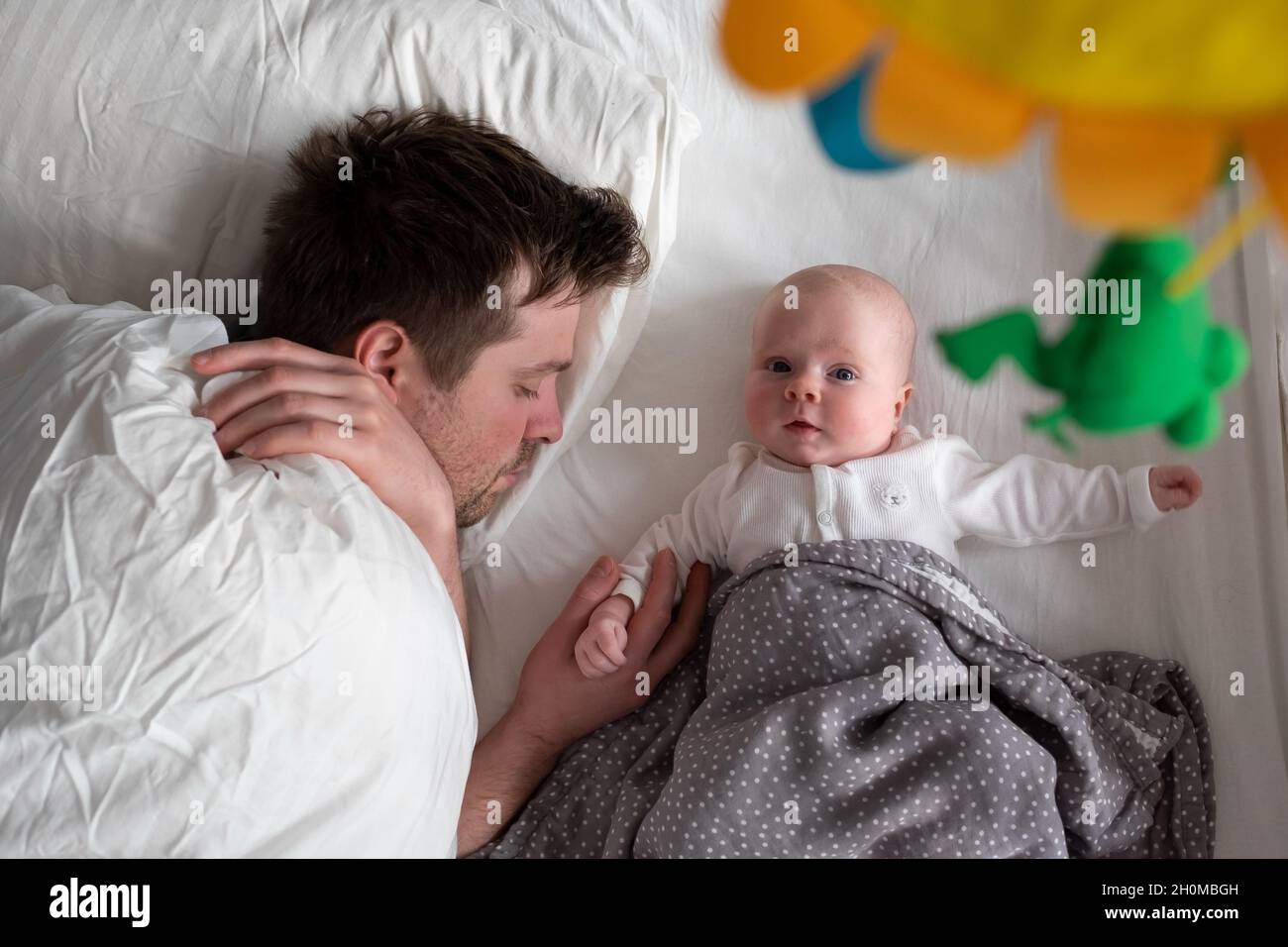 Sleeping father and cute child resting together in bed Stock Photo - Alamy