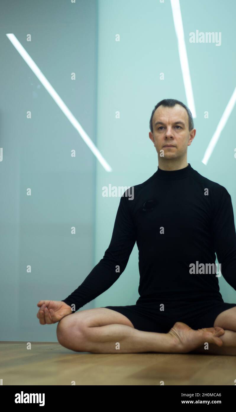 Male instructor yoga teacher teaching asana pose with mudra hand ...