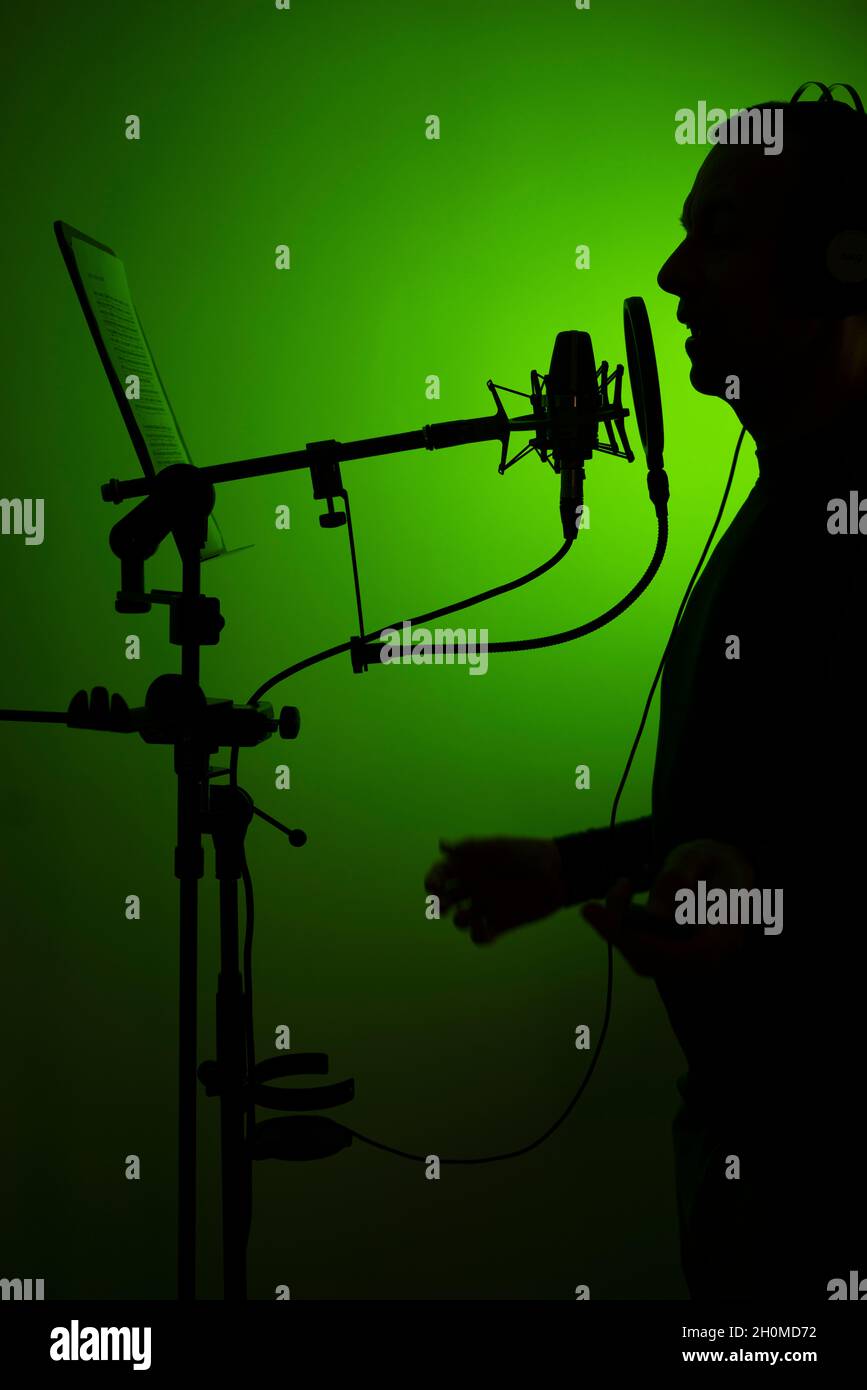 Voiceover artist actor recording voice overs in professional audio ...