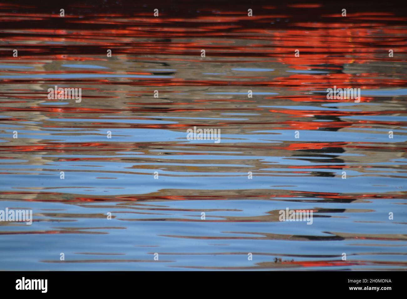 Reflections of boats in harbour water Stock Photo - Alamy