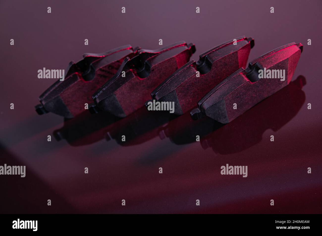 set of car brake pads for car safety on stylish red background, depth ...