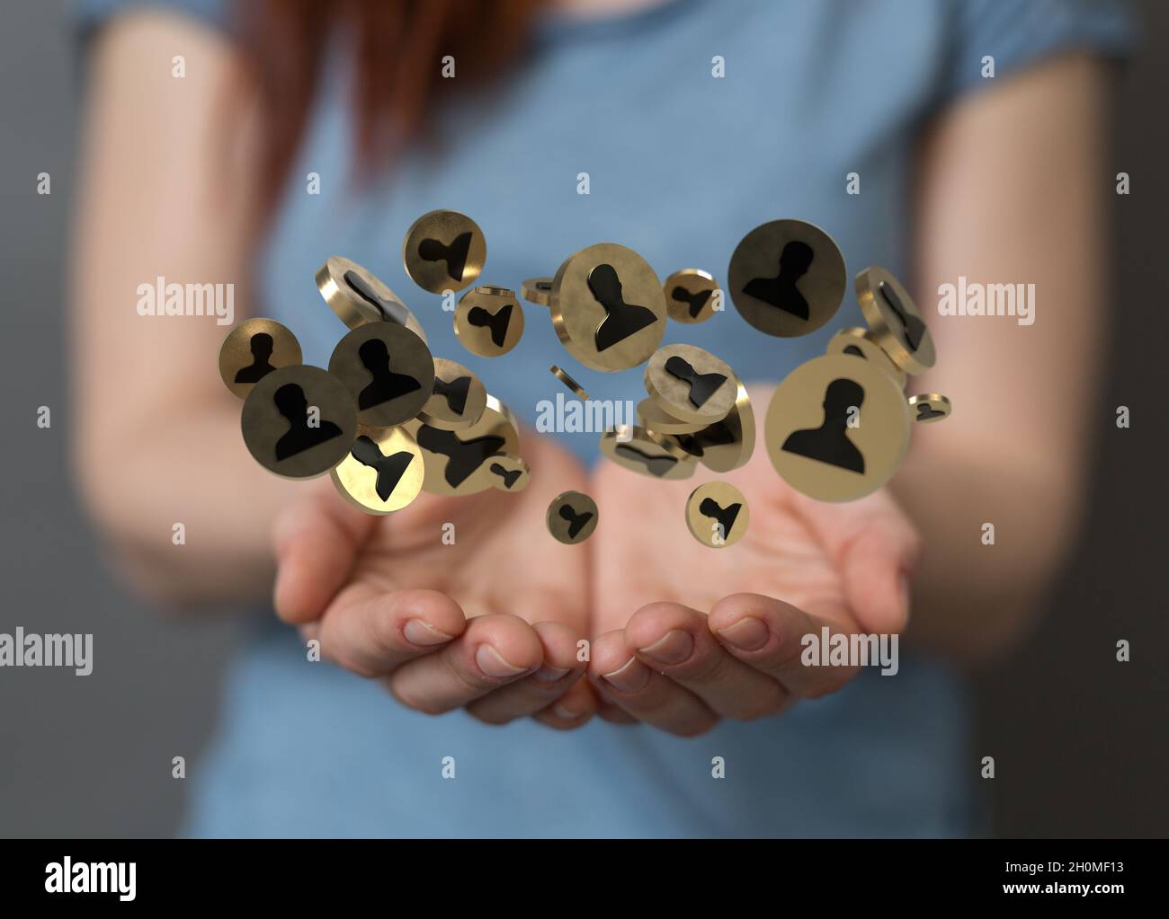 Hand holding 2D people icons Stock Photo - Alamy