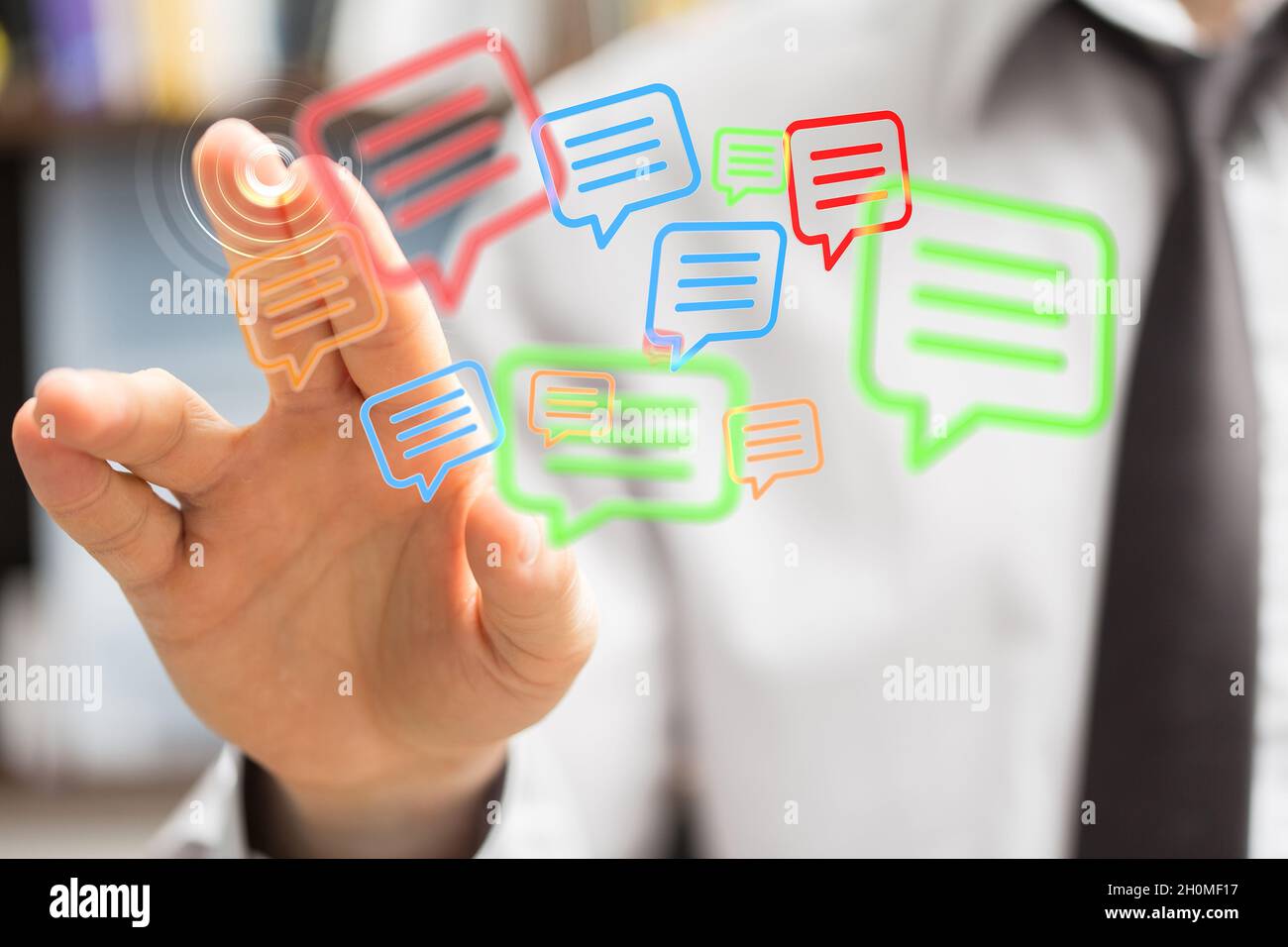 Hand tapping 2D message icons Stock Photo - Alamy