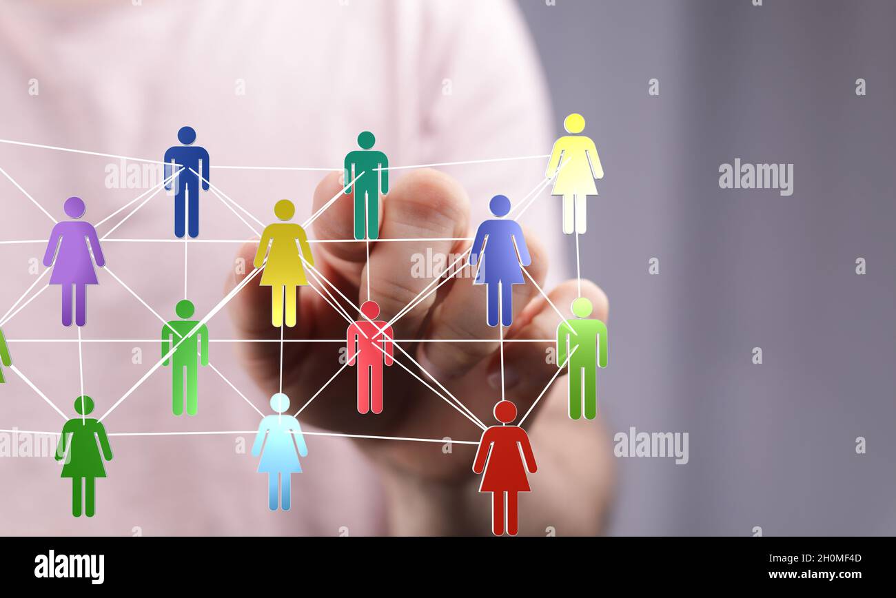 Hand holding 2D people icons Stock Photo - Alamy