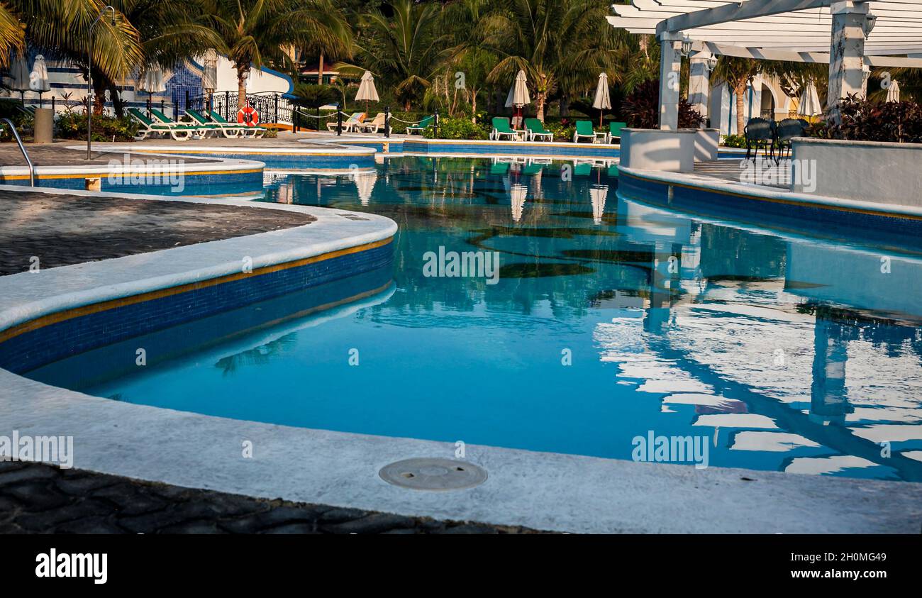 Modern and luxurious hotel pool with beach umbrellas and loungers ...