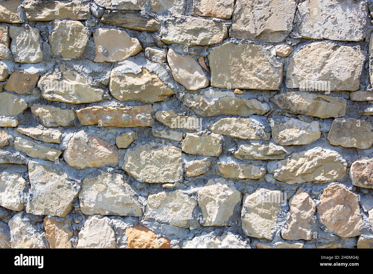 The rough textured surface of the wild stone wall. Background Stock ...