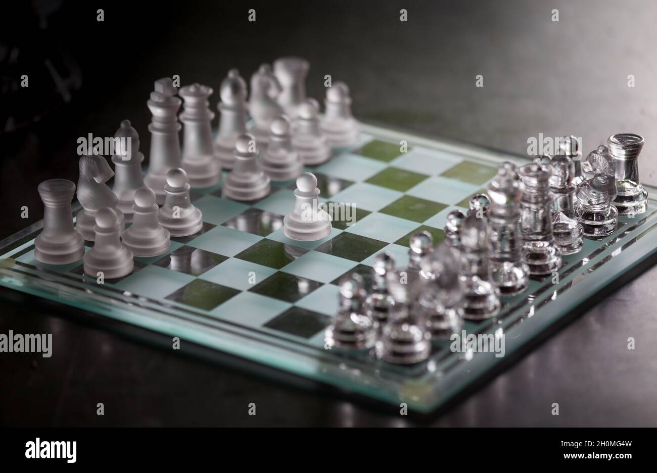 Chess board with glass pieces, opening. Black and white image Stock ...