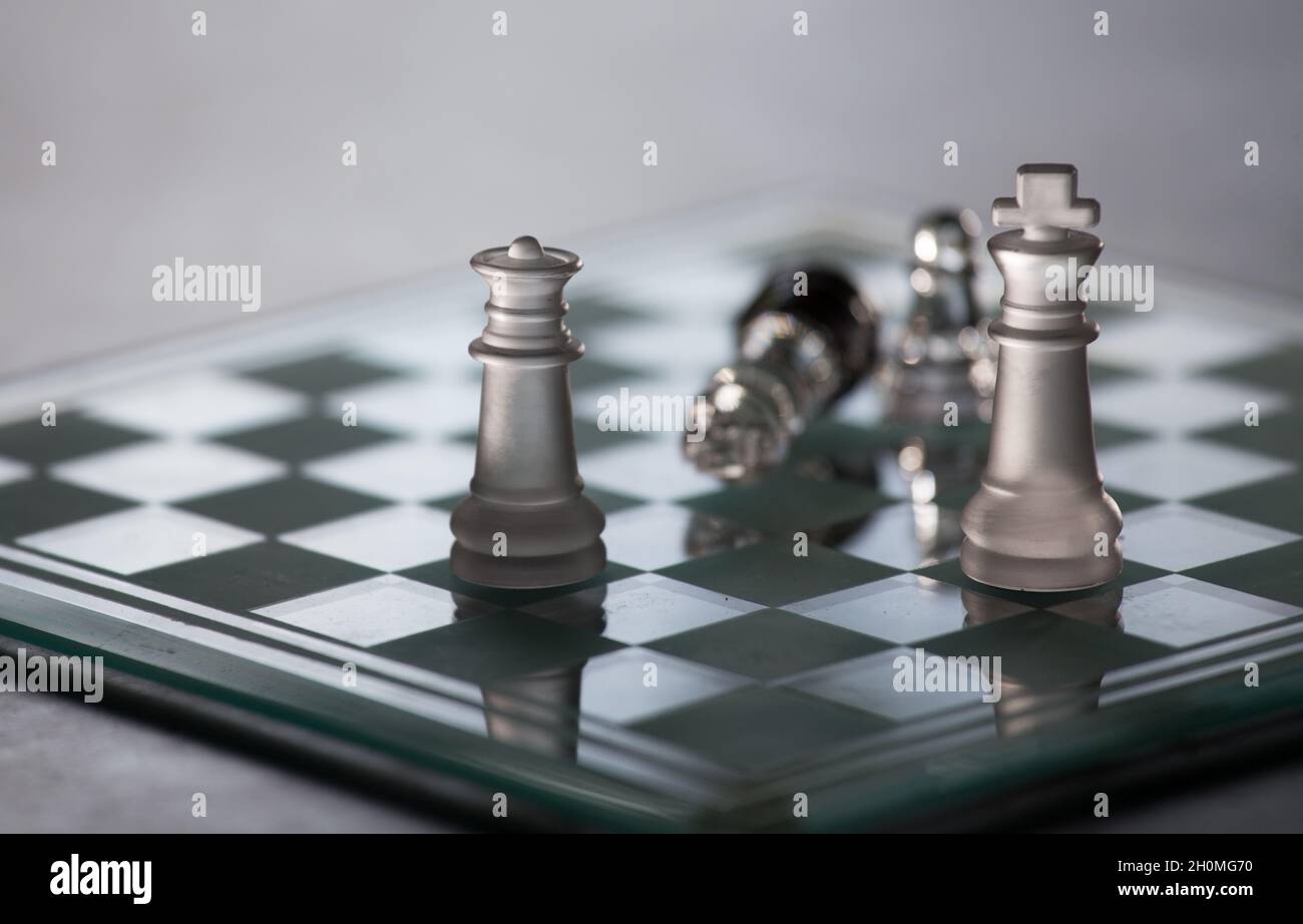 Chess board with glass pieces. Chessmate position. Black and white ...