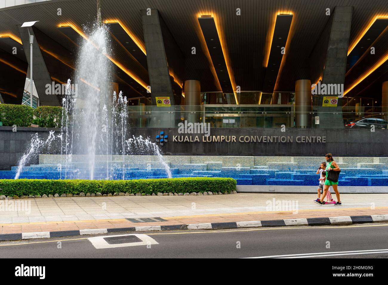 Main Entrance of Kuala Lumpur Convention Centre, with people walking by ...