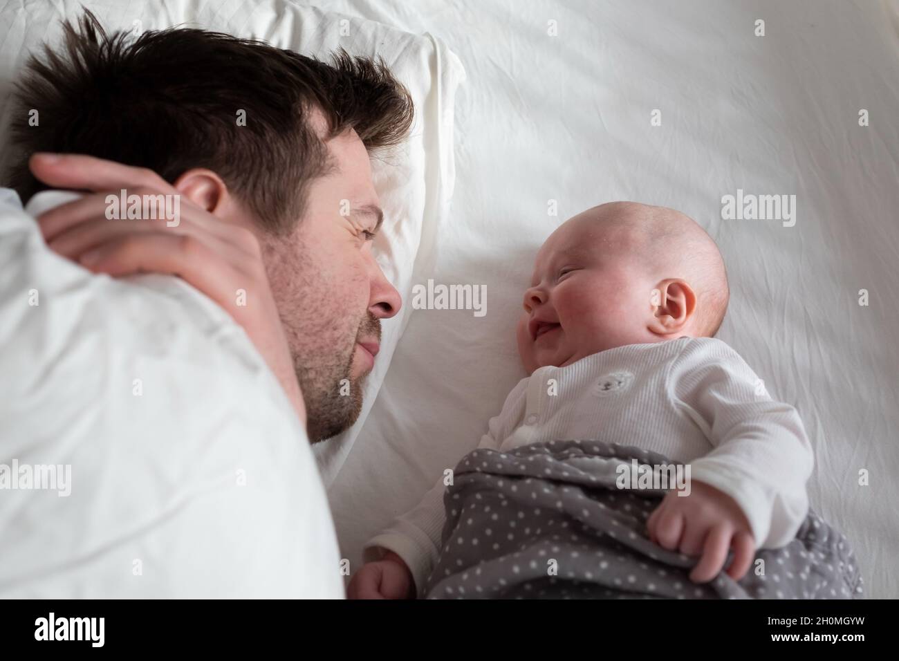 Sleeping father and cute child resting together in bed Stock Photo - Alamy