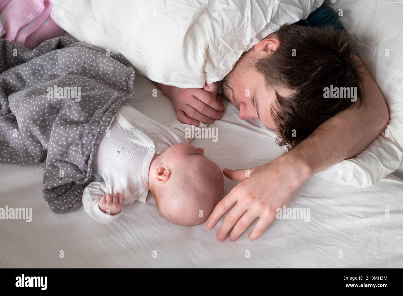Sleeping father and cute child resting together in bed Stock Photo - Alamy