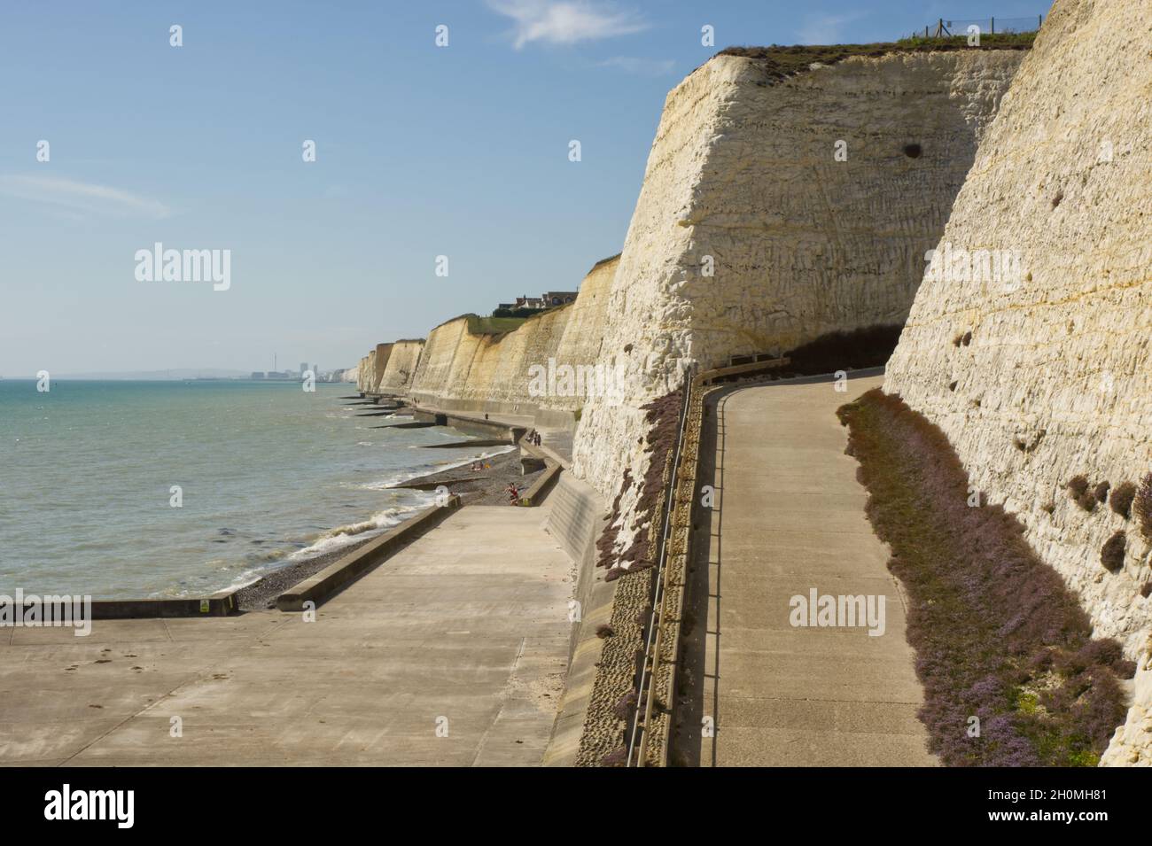 Seafront promenade and white chalk cliffs at Peacehaven in East Sussex ...