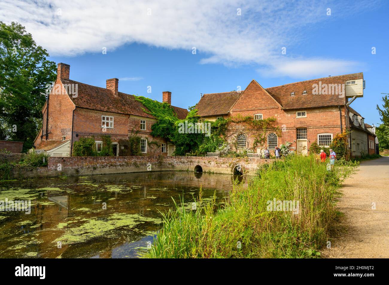 View to the Flatford Mill red brick buildings from the road next to ...