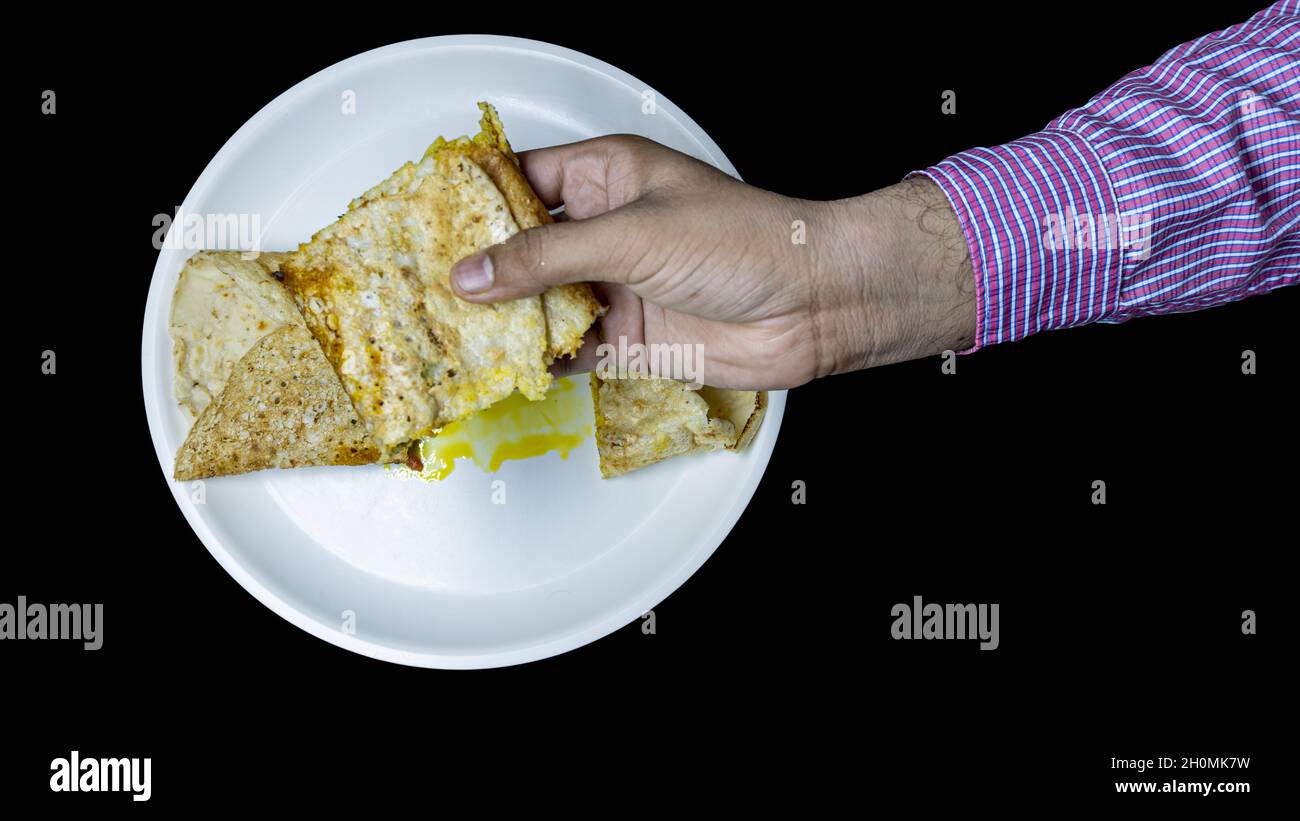 Traditional Indian cuisine. Piece Of Vegetarian Dosa In Hand Stock ...