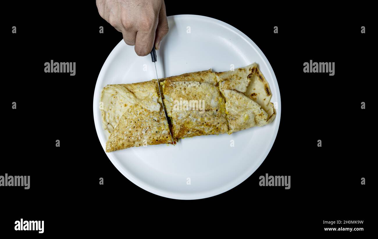 Traditional Indian cuisine. Cut The Vegetarian Dosa With A Knife Stock ...