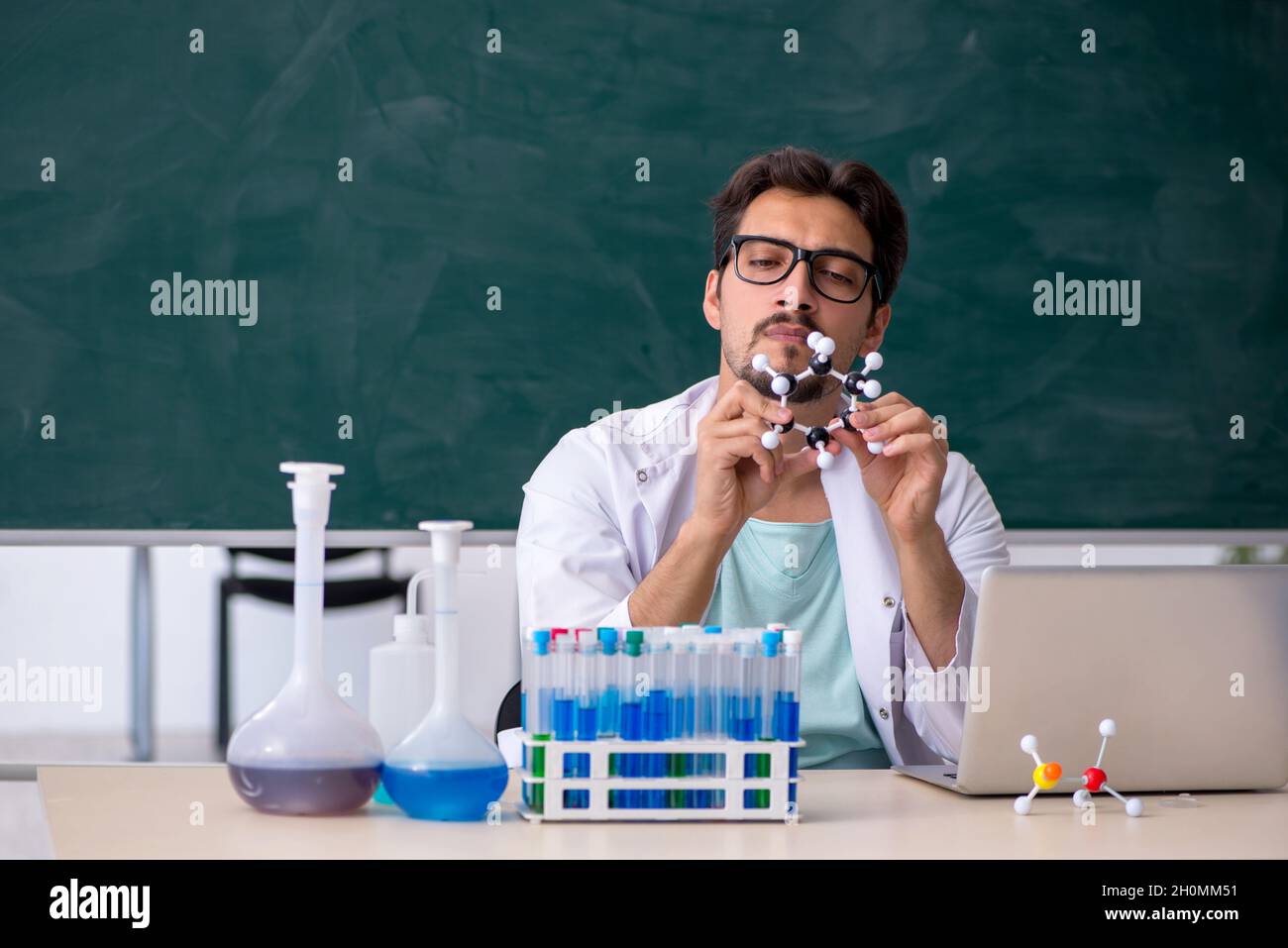 Young chemist in front of blackboard Stock Photo - Alamy