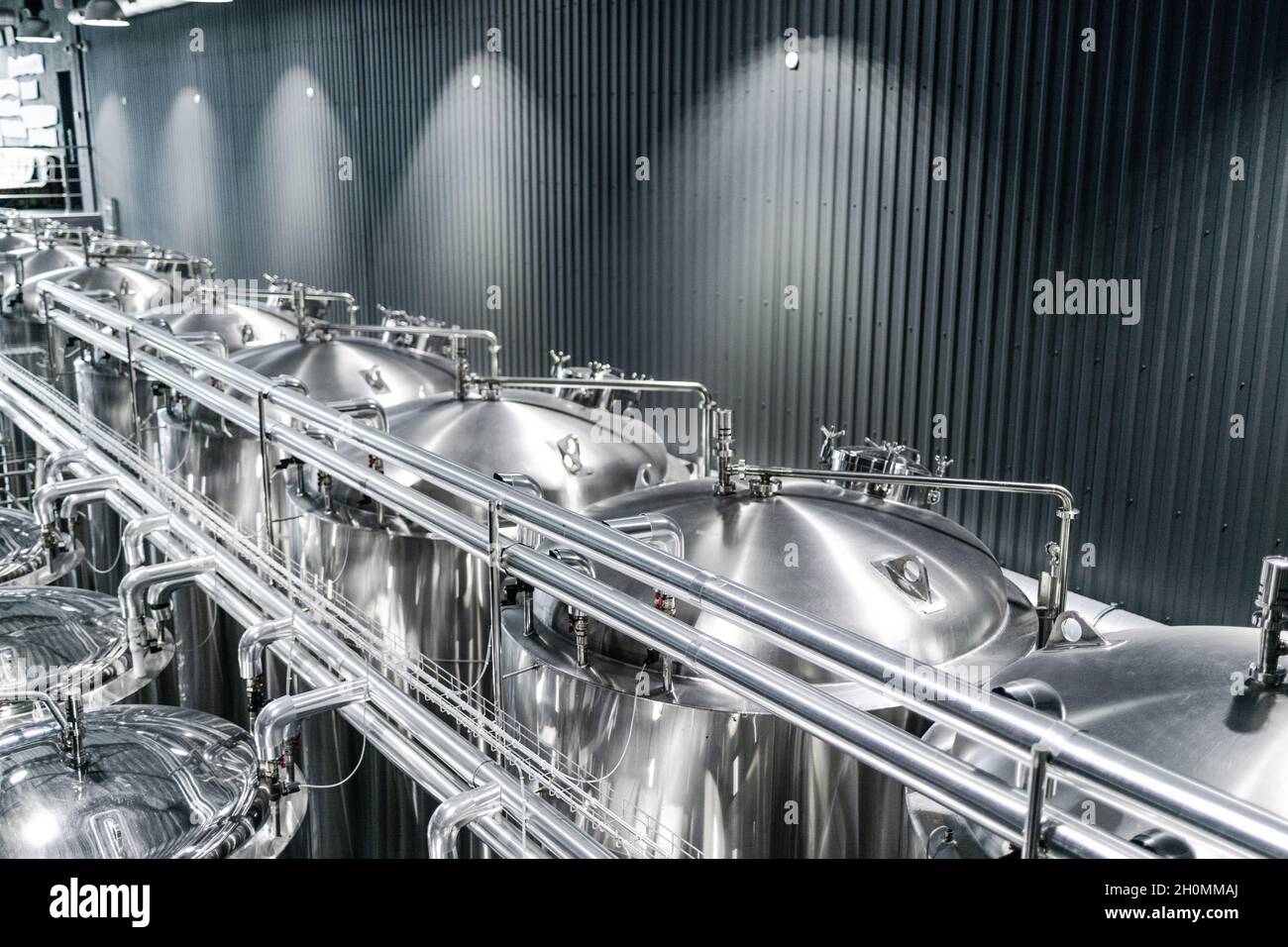 Private microbrewery. Modern beer plant with brewering kettles, tubes ...