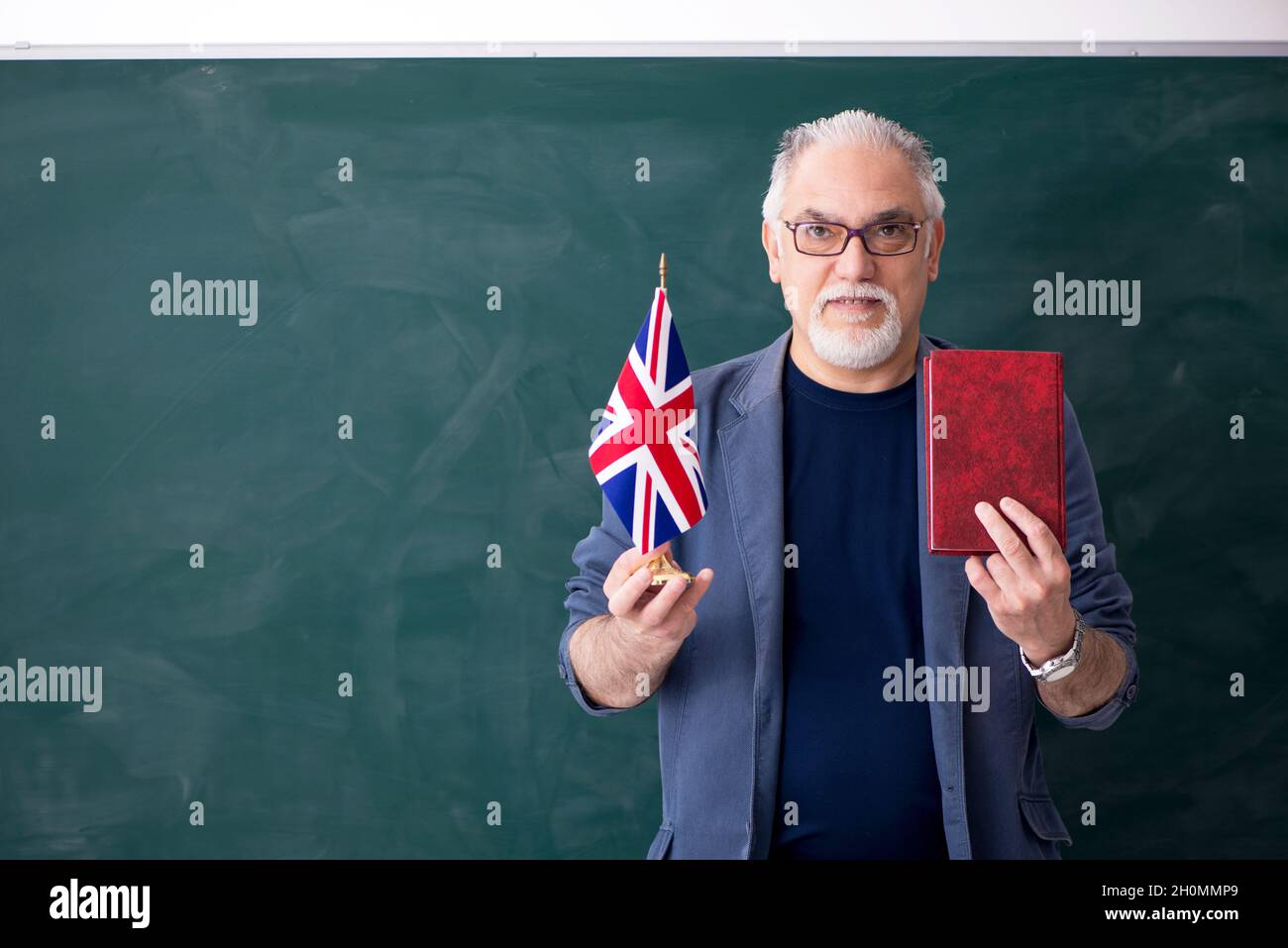 Old english language teacher in the classroom Stock Photo - Alamy