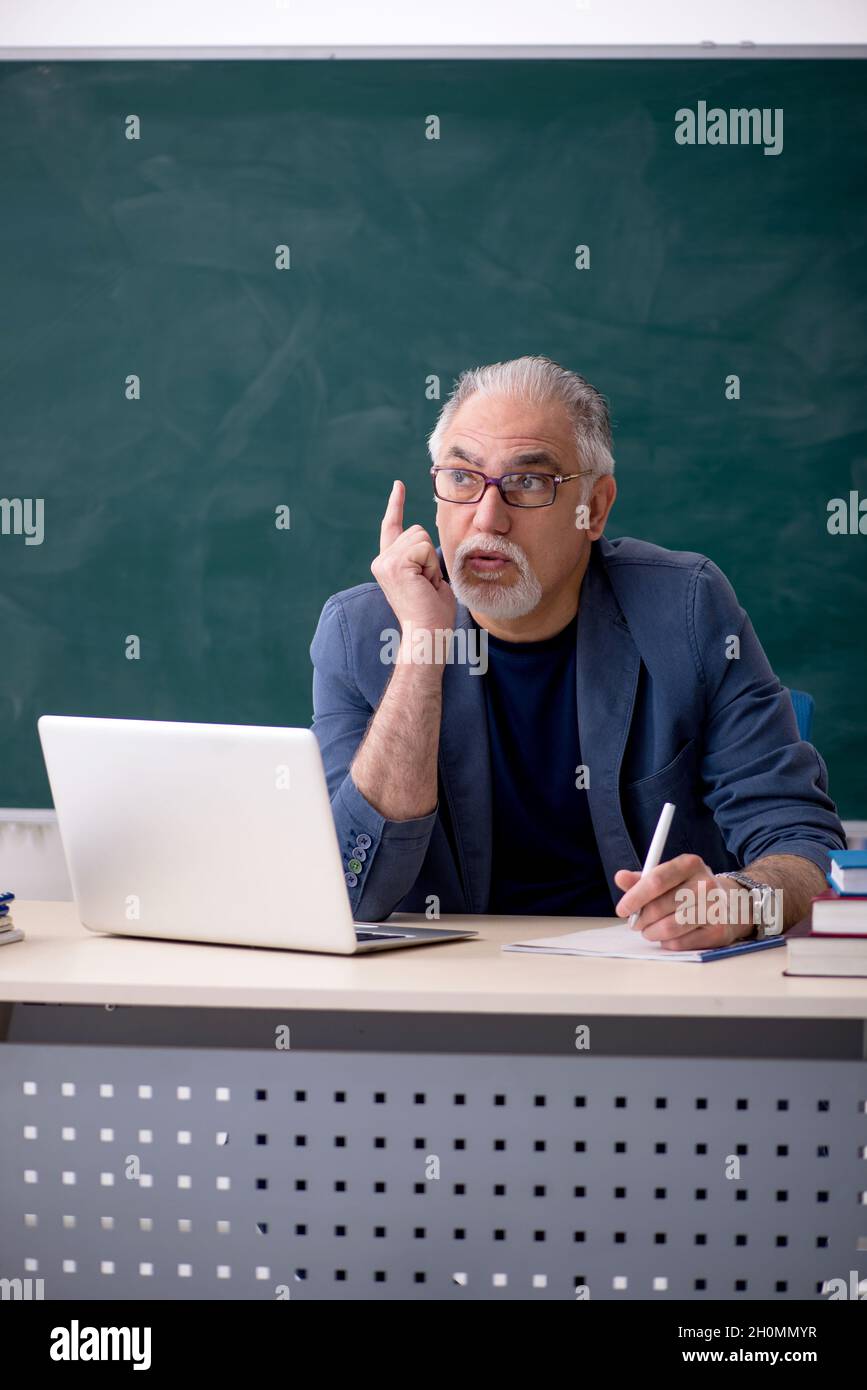Old teacher in the classroom Stock Photo - Alamy