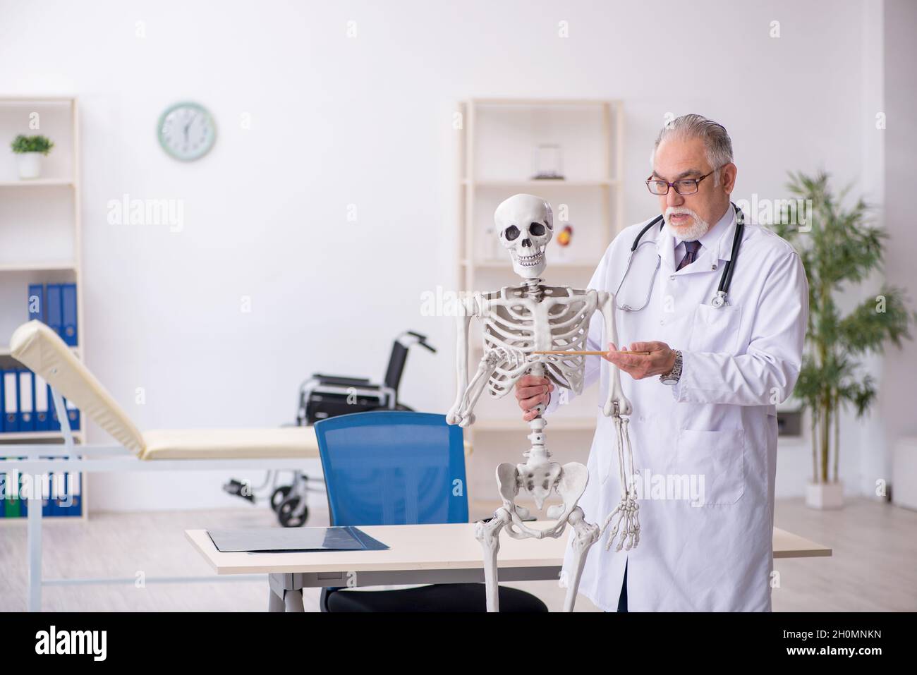 Old doctor demonstrating human skeleton Stock Photo - Alamy