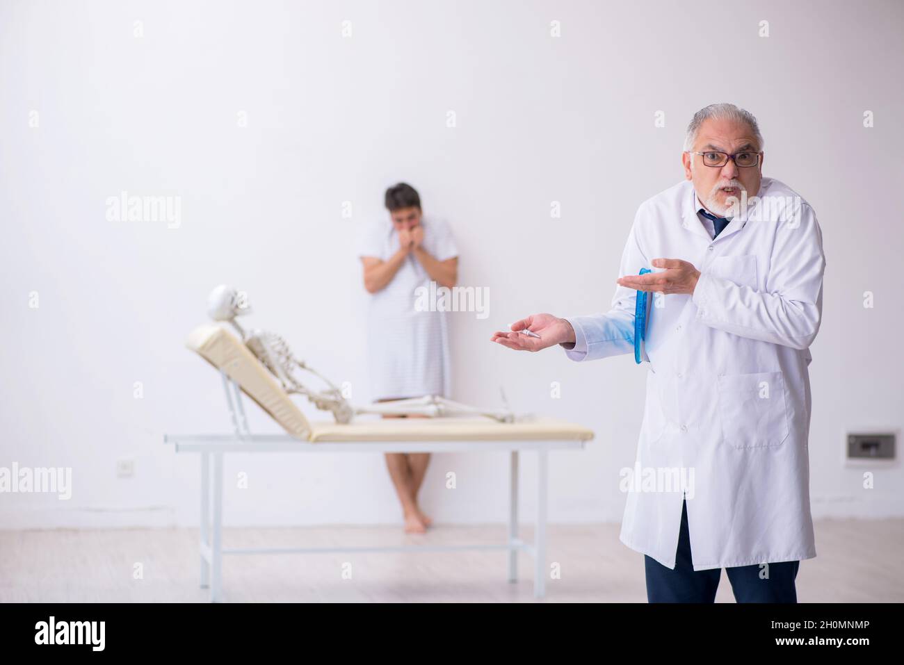 Old doctor psychiatrist examining young male patient Stock Photo - Alamy