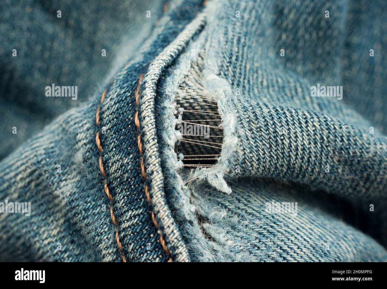 A hole in jeans close-up. Ripped holey jeans Stock Photo - Alamy