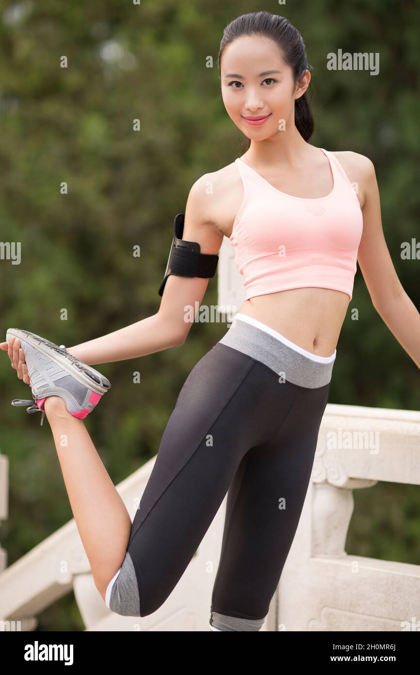 Energetic young woman doing exercise Stock Photo - Alamy