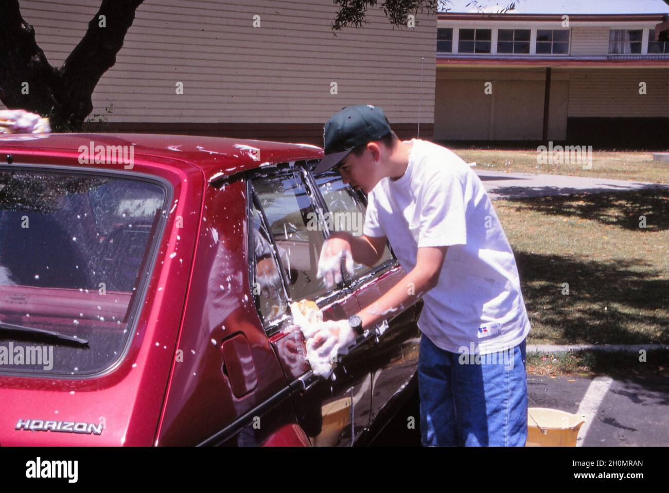 Teenage boy washing car hi-res stock photography and images - Alamy