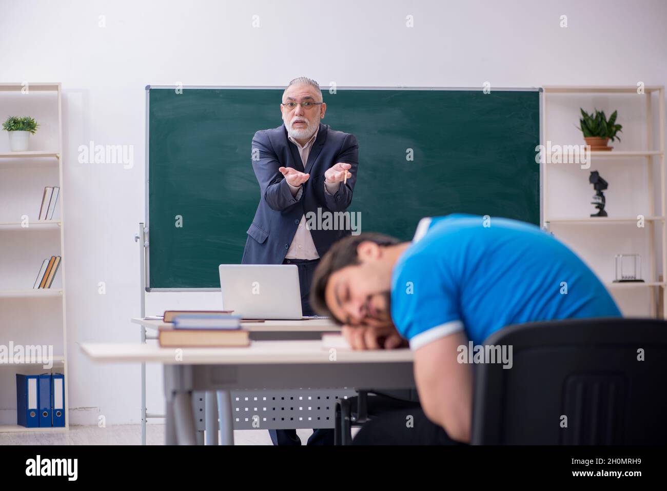Young student sleeping in the classroom Stock Photo - Alamy