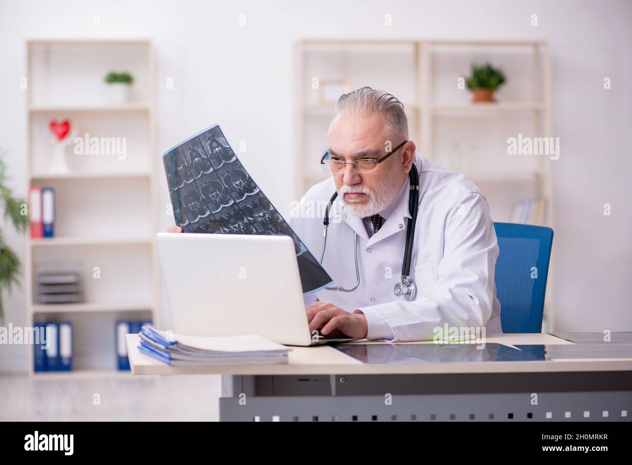 Old doctor radiologist working in the clinic Stock Photo - Alamy