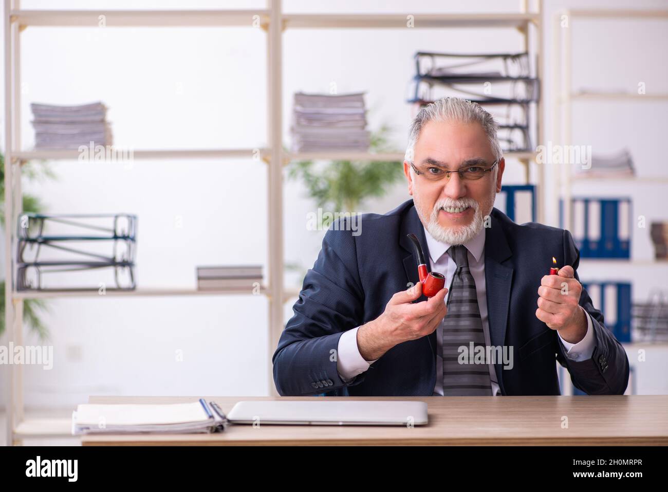 Old businessman employee smoking pipe at workplace Stock Photo - Alamy