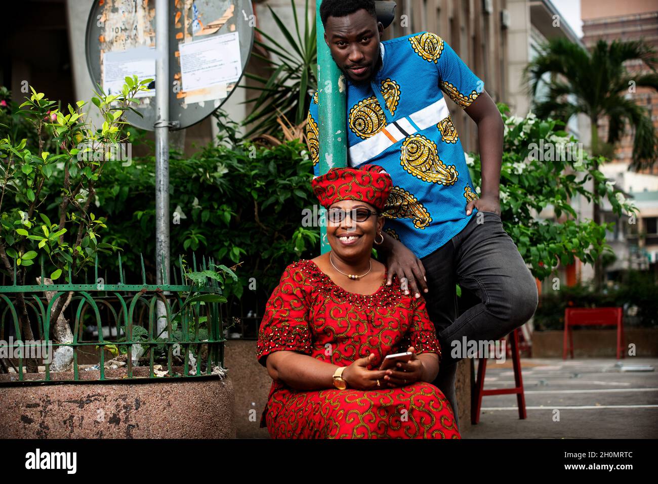 handsome young man standing over woman sitting posing together looking ...
