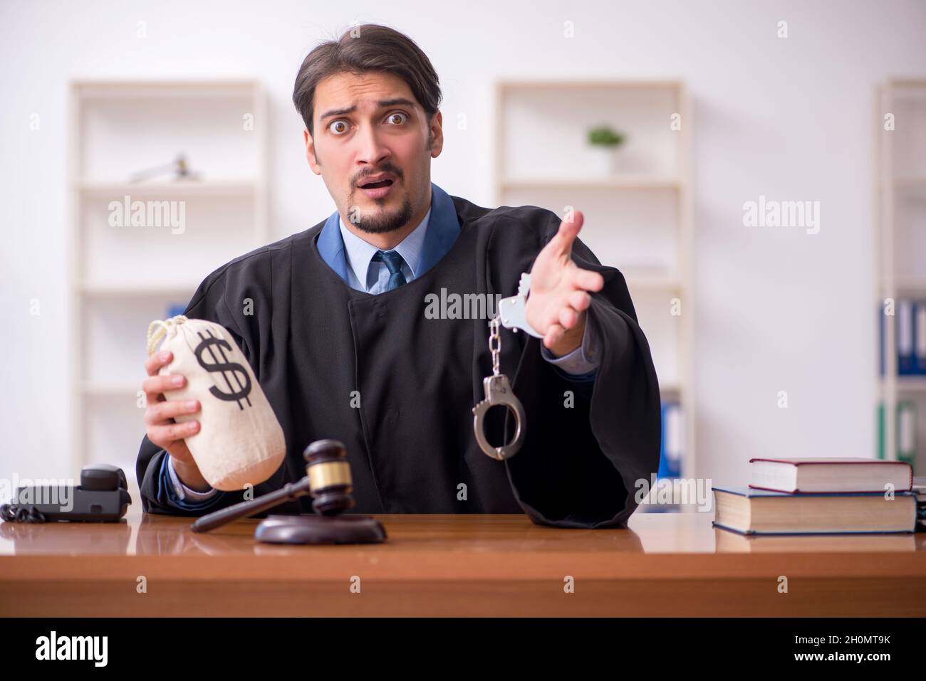 Young judge working in the courtroom Stock Photo - Alamy