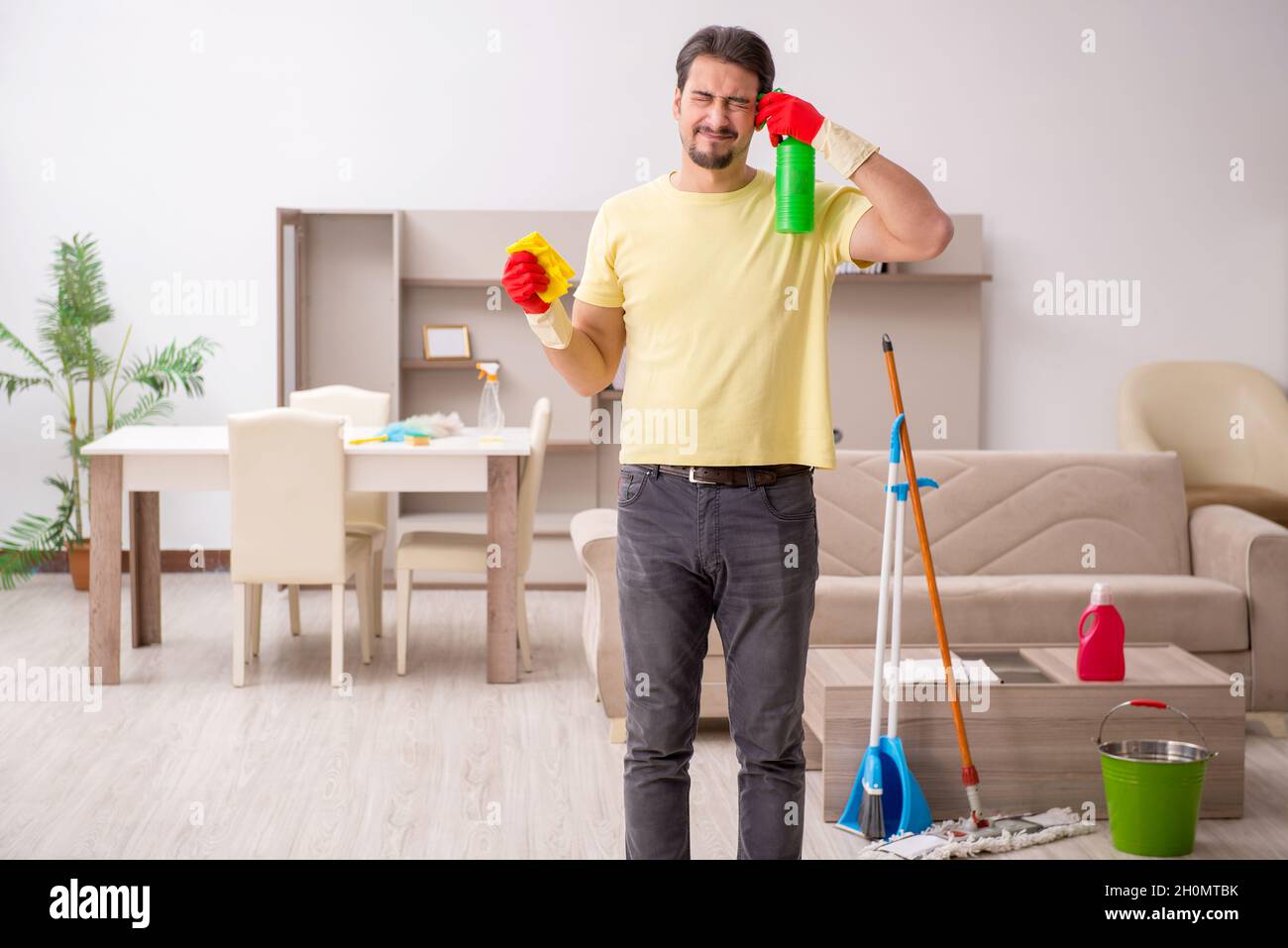Young male cleaner cleaning the house Stock Photo - Alamy