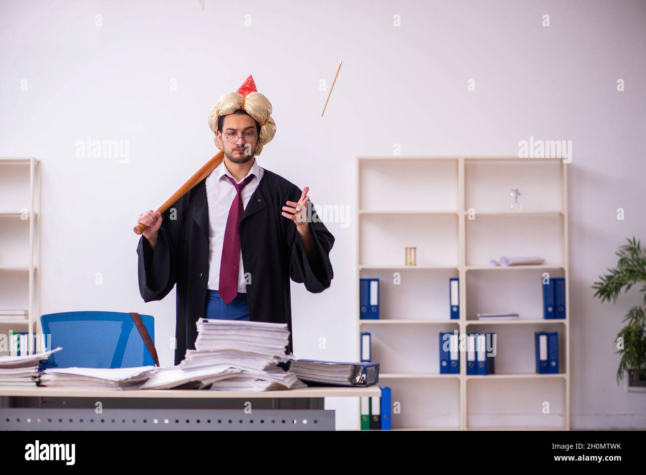 Funny young employee magician and too much work in the office Stock ...