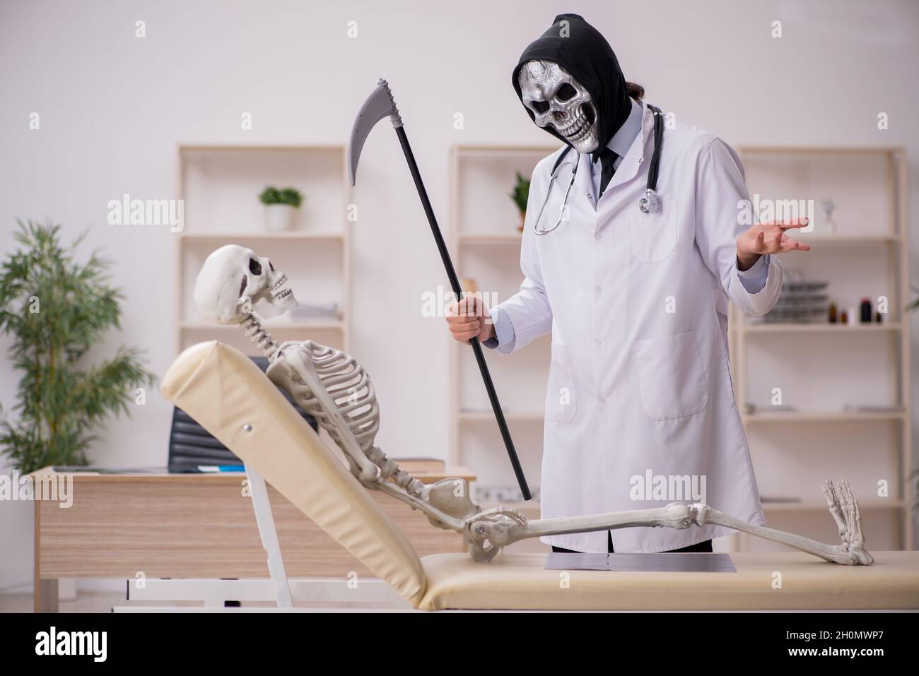 Reaper grim doctor examining skeleton patient in the clinic Stock Photo ...