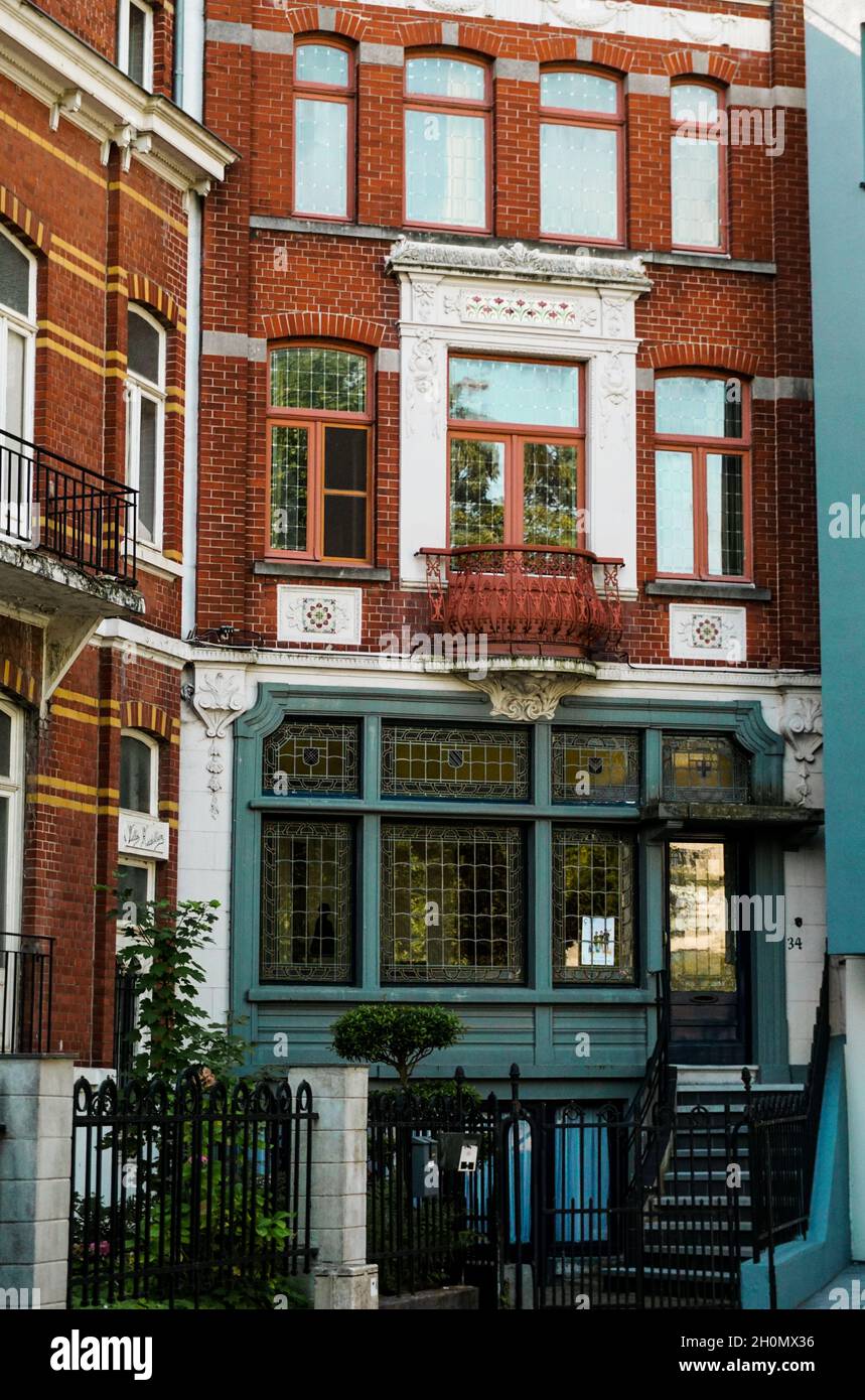 Vertical shot of a building of red bricks with beautiful fence and ...