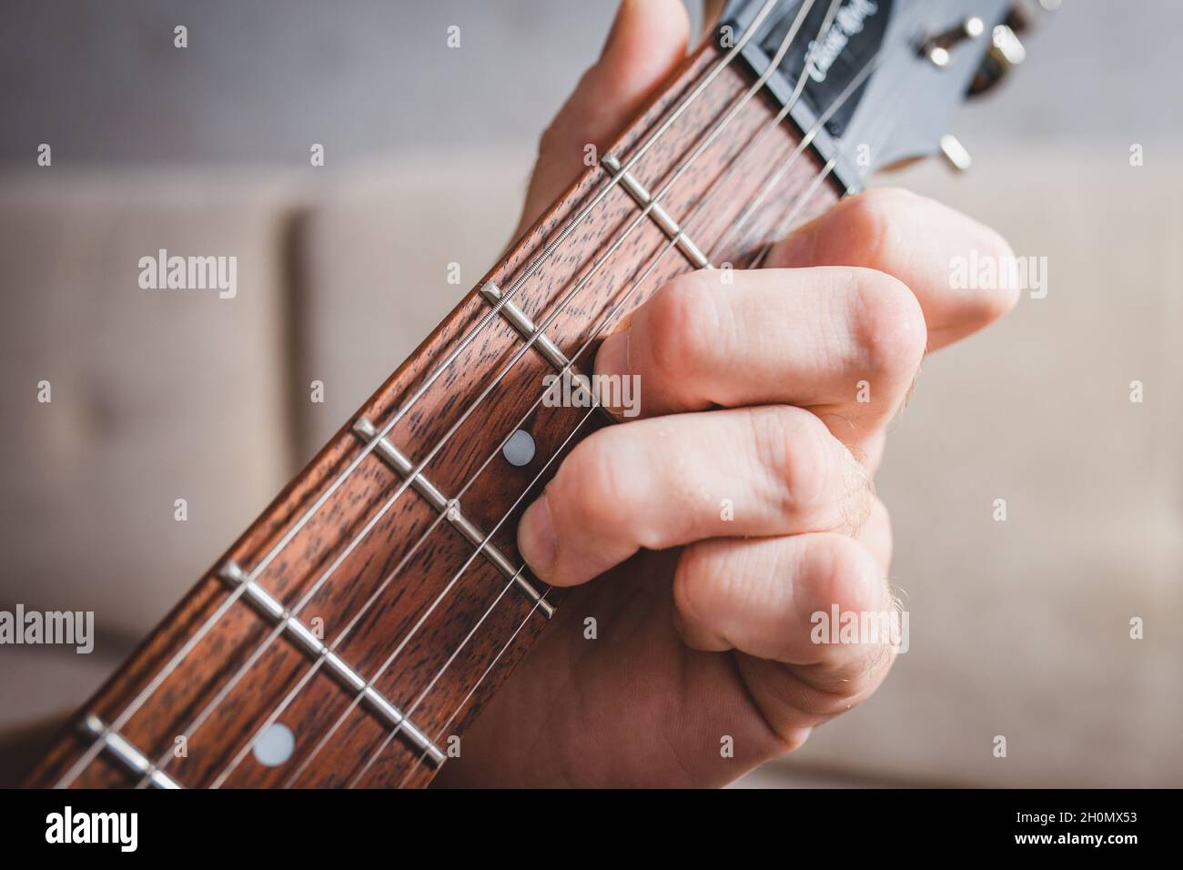 Dm chord - close-up male Caucasian hand takes a chord on a 6 string ...