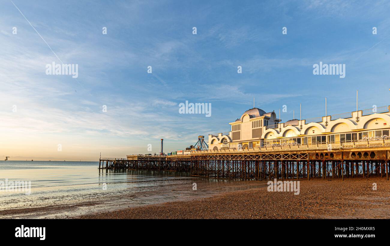 South Parade Pier on Southsea Beach at sunrise with a low tide and blue ...