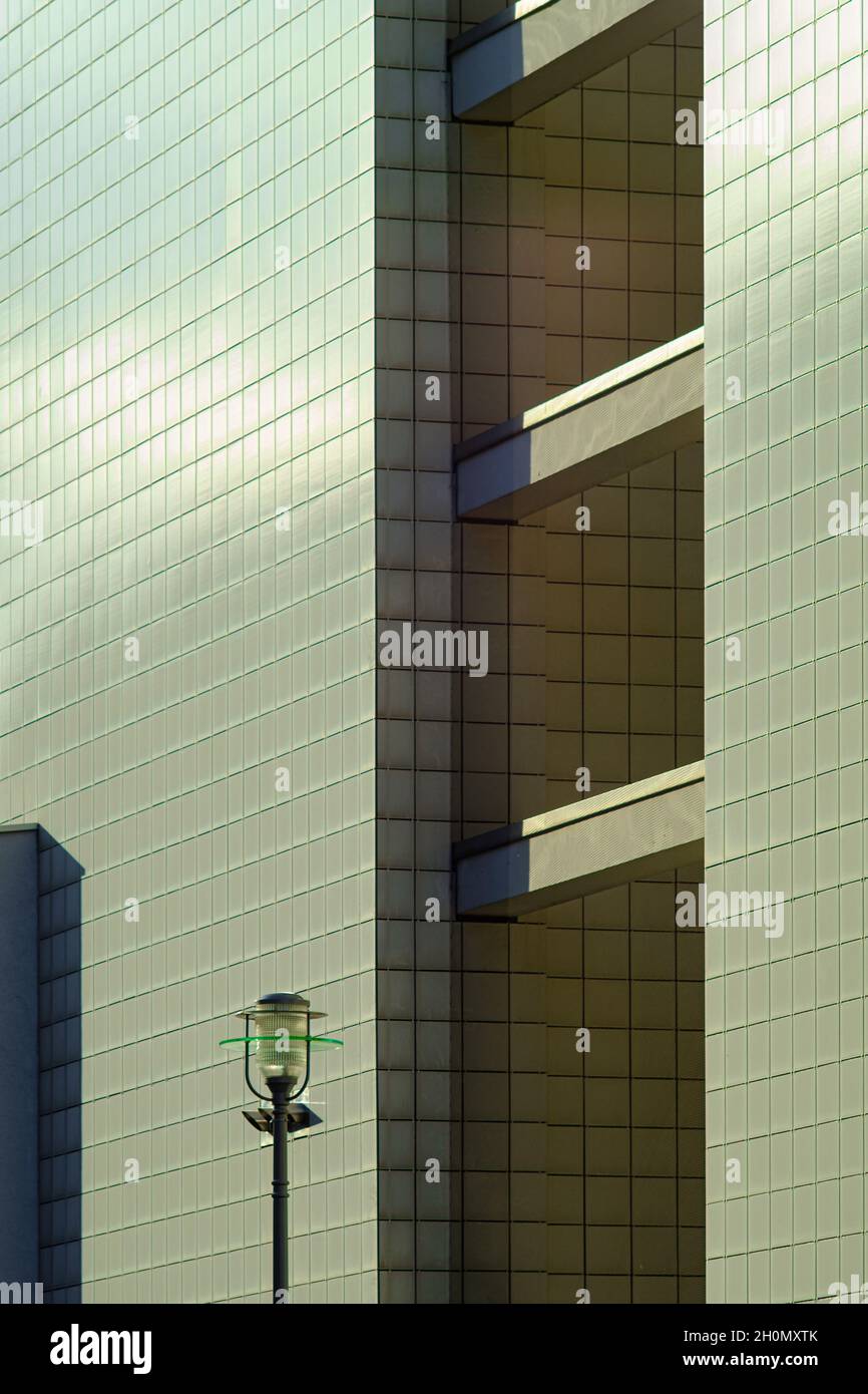 Vertical shot of a modern building wall with half-opened parts under ...