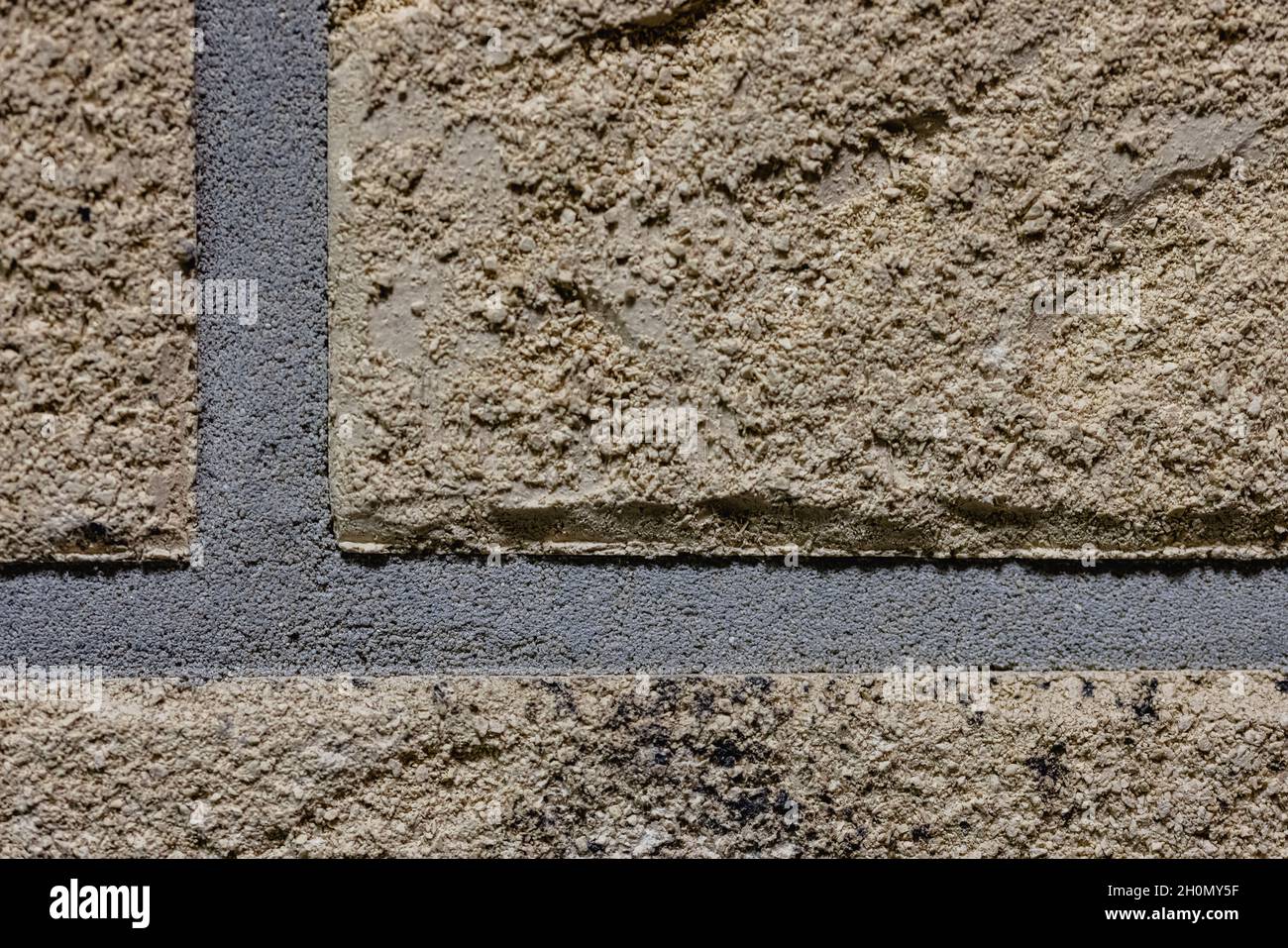 Close-up texture of a brown scratched brick wall with a gray seam Stock ...