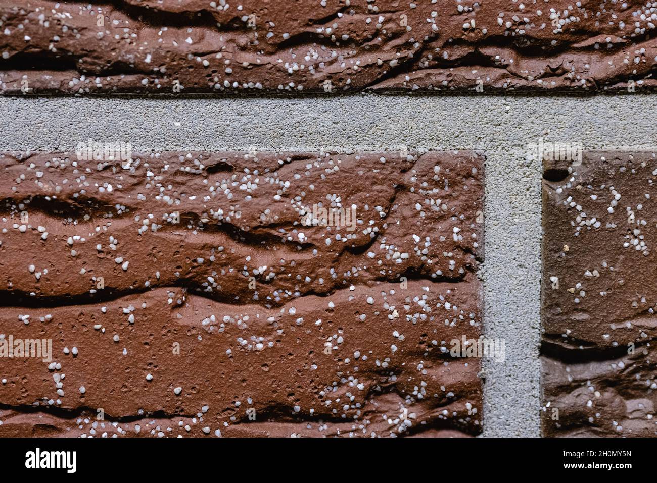 Close-up texture of a red scratched brick wall with a gray seam Stock ...